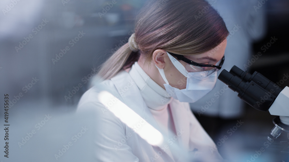 Diverse scientists studying medical samples and human skeleton. Using ...