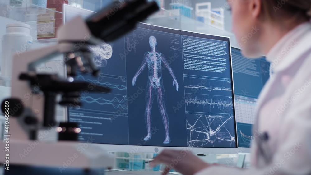 Female doctor working in laboratory. Studying human skeleton and DNA ...