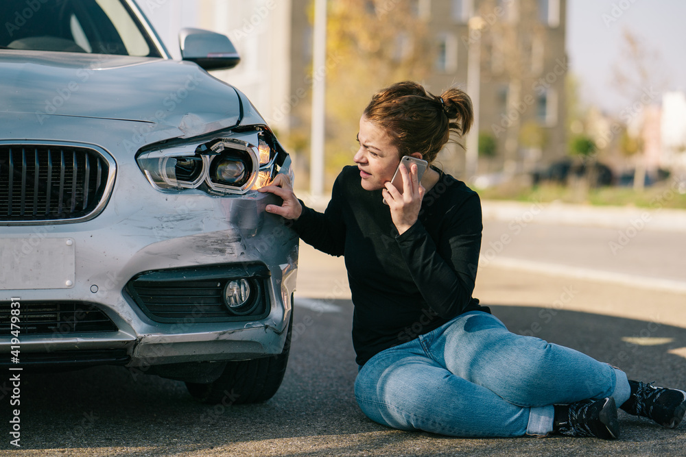 Full body of upset young female driver in casual outfit having phone ...