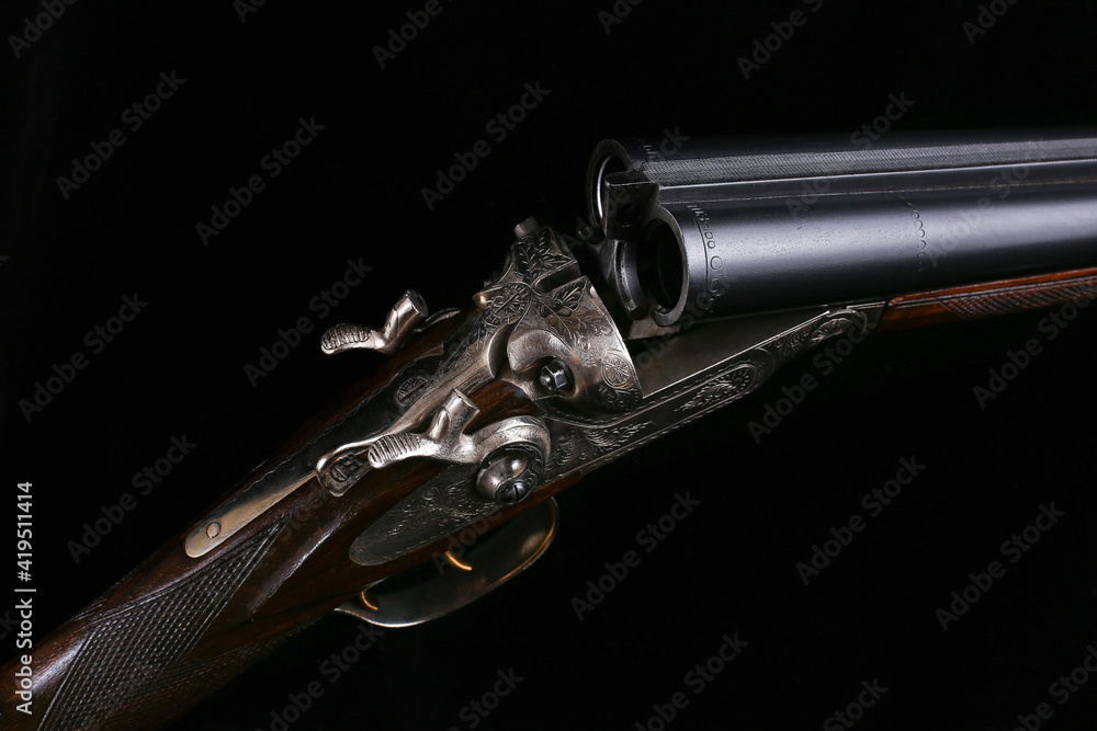Details of an elegant double-barreled hunting classic shotgun on a ...