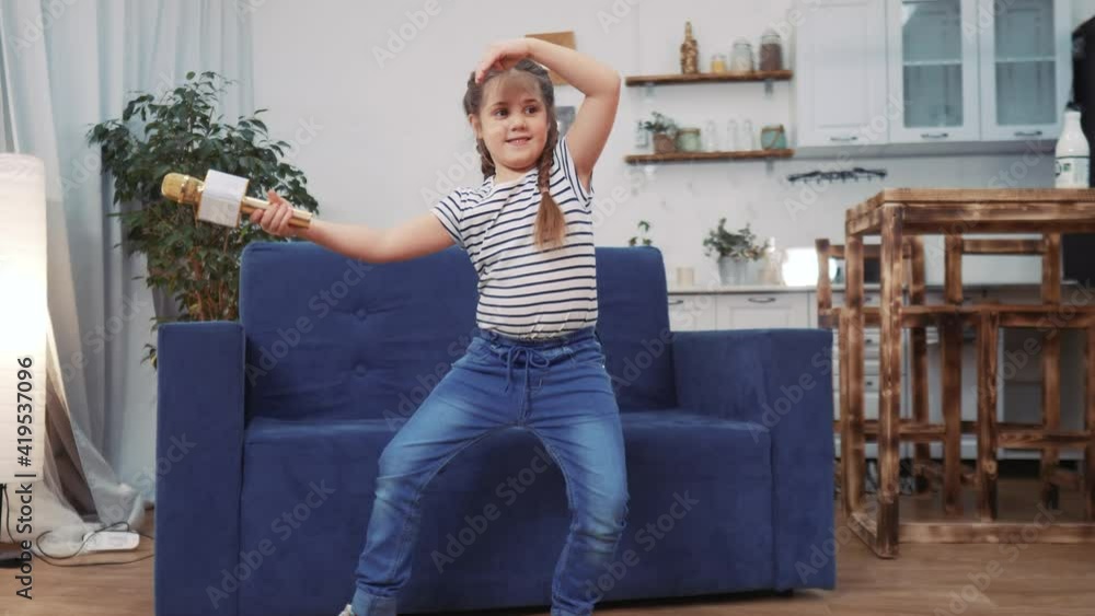 little child daughter a sing dancing at home. stay home active leisure ...