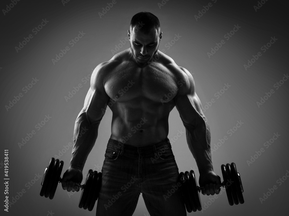 Muscular strong men bodybuilder stands holding, lifting big heavy ...