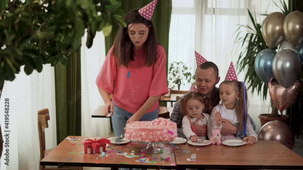 Cheerful family throwing a party. Happy parents and children celebrate ...