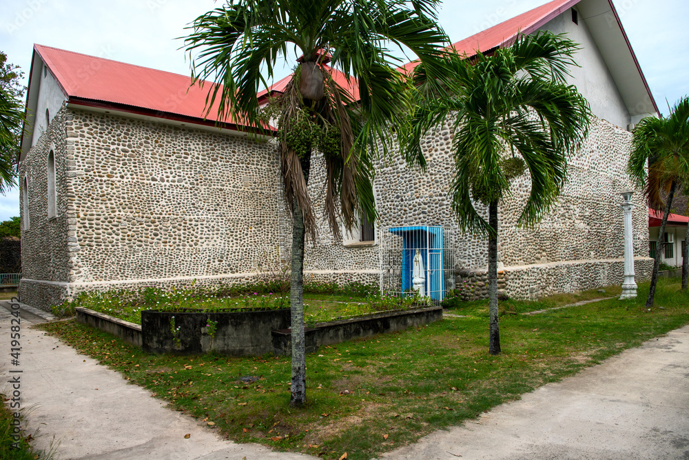 Catholic church and Virgin Mary statue in tropical garden. South Asia ...