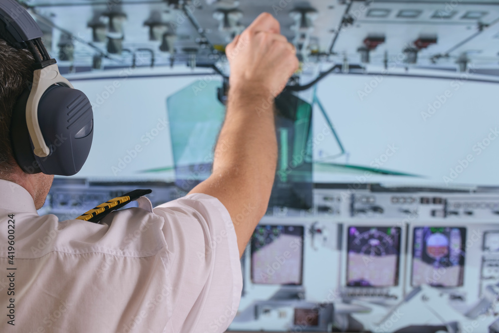 Airline pilot wearing uniform with epauletes Stock Photo | Adobe Stock