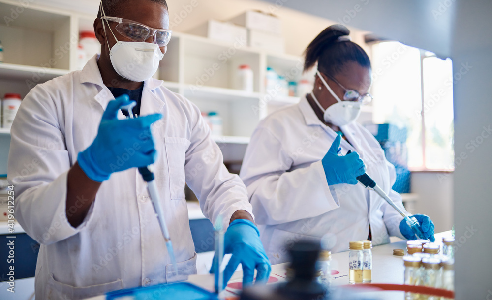 African technicians analyzing samples together in a lab Stock Photo ...