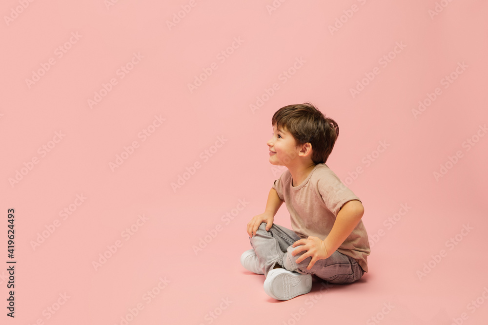Dreaming, smiling. Happy, smiley little caucasian boy isolated on pink ...