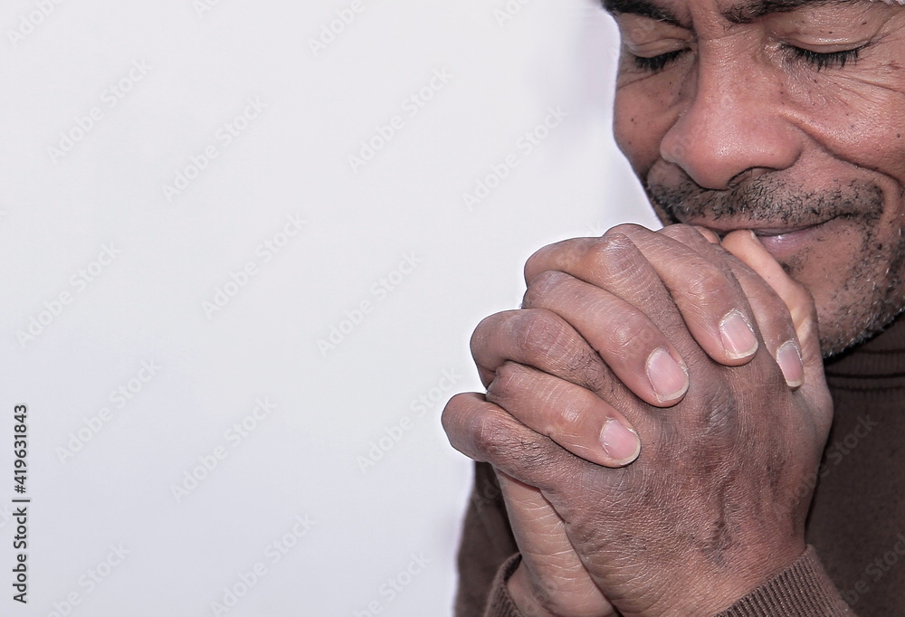 man praying to god with hands together Caribbean man praying with grey ...