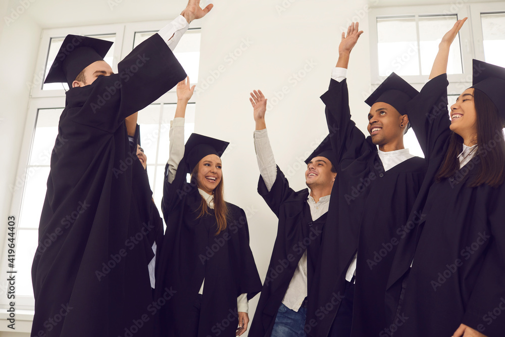 Boys and girls are happy to be graduates. Group of happy multiracial ...
