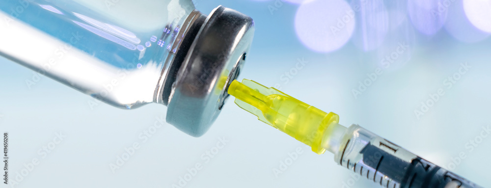 Vaccine vial dose flu shot drug needle syringe on blue background ...