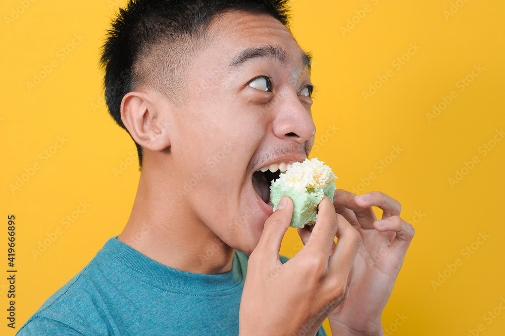 Happy Excited Young Asian man eating cake Stock Photo | Adobe Stock