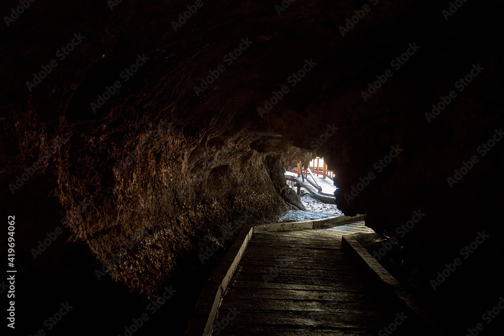 Old stone bat cave in the rock. Tourist attraction. Walk in the cave ...