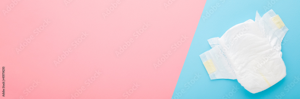 White soft new baby diaper on light pink blue table background. Pastel ...