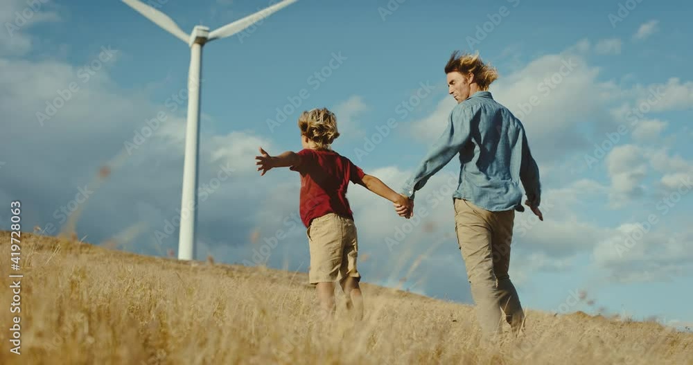Father and son looking towards a clean and sustainable energy future ...