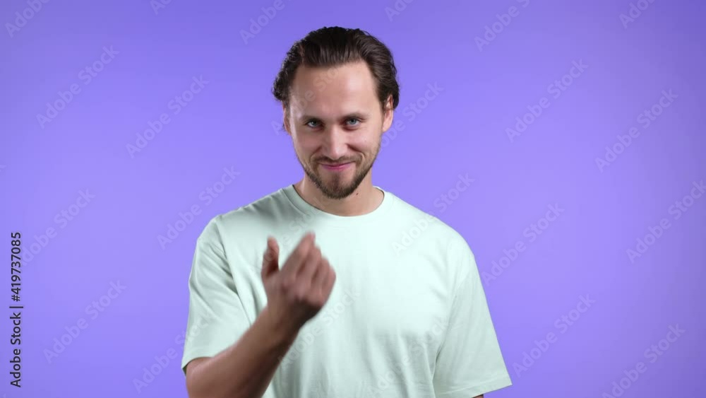 Handsome man showing - Hey you, come here. European smiling guy asks ...