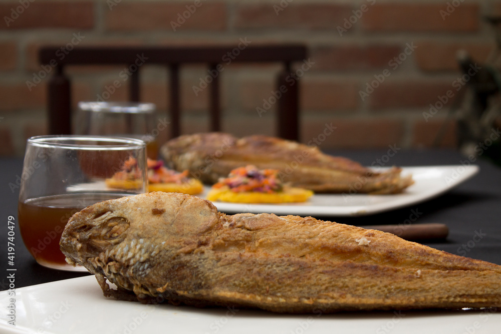 Fried fish with plantains and grated carrot salad, cabbage, lettuce ...