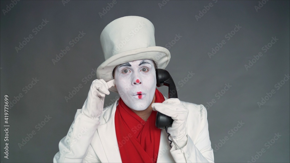 Mime calls by phone. Mime with an old pipe. boy-mime with the phone ...