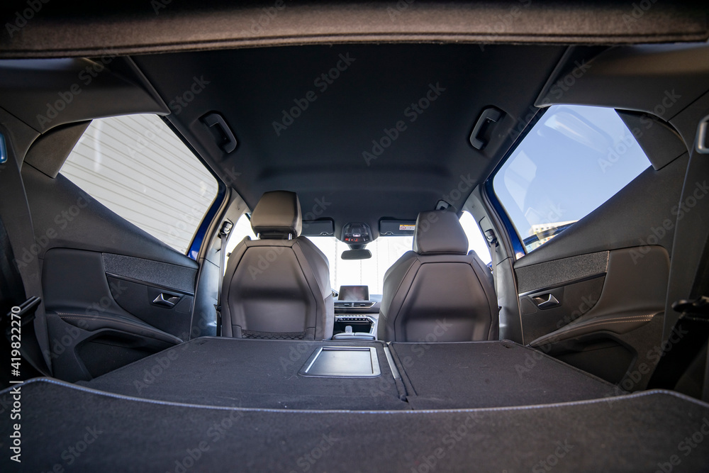 empty trunk of a modern car with folded rear seats. large interior ...