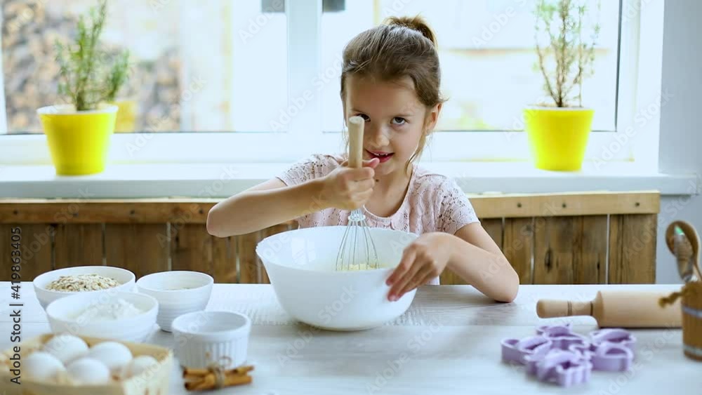 7 years old school girl cooking at the kitchen, casual lifestyle ...