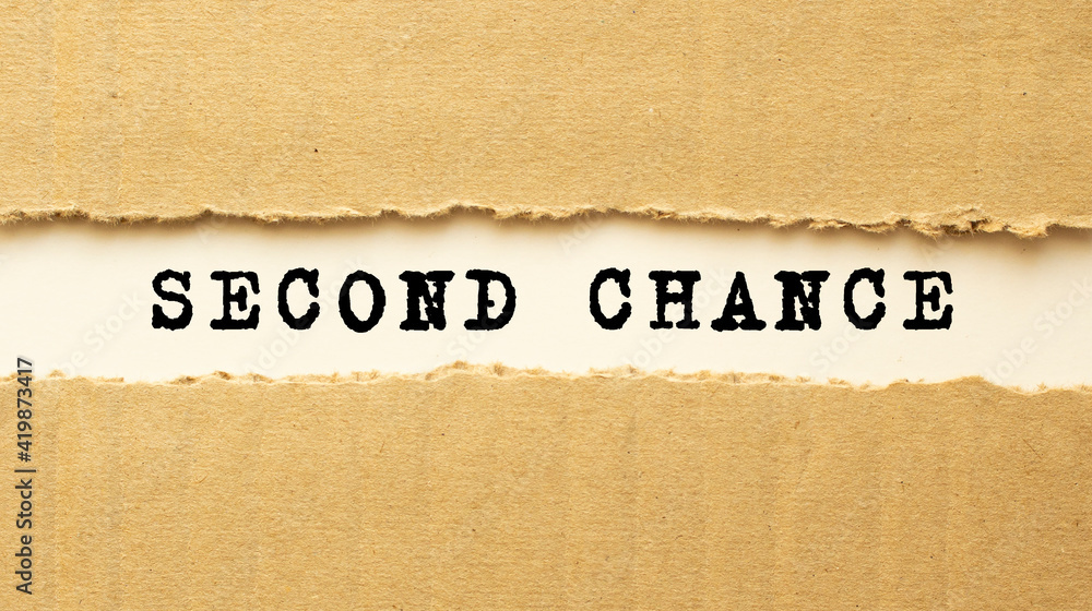 Text SECOND CHANCE appearing behind torn brown paper. Top view. Stock ...