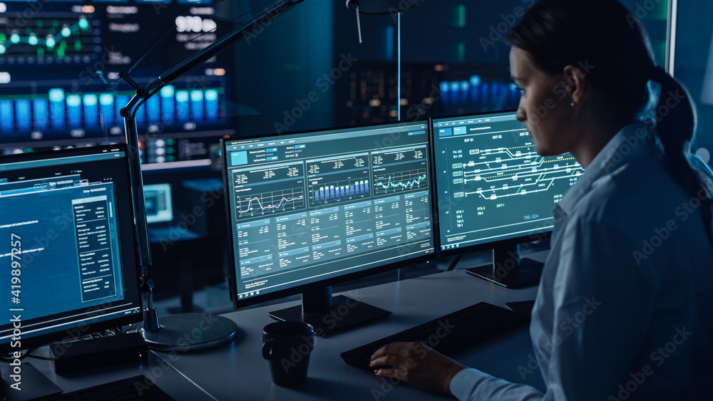 Female Software Engineer Working in a Modern Monitoring Office with ...