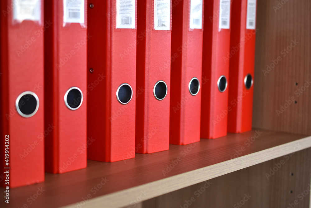 Office red folders on the shelf in the office Stock Photo | Adobe Stock