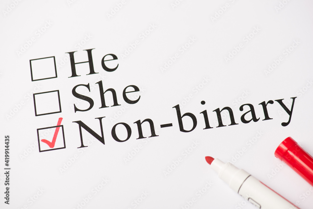 Non-binary concept. Above photo of red color marker and paper with text ...