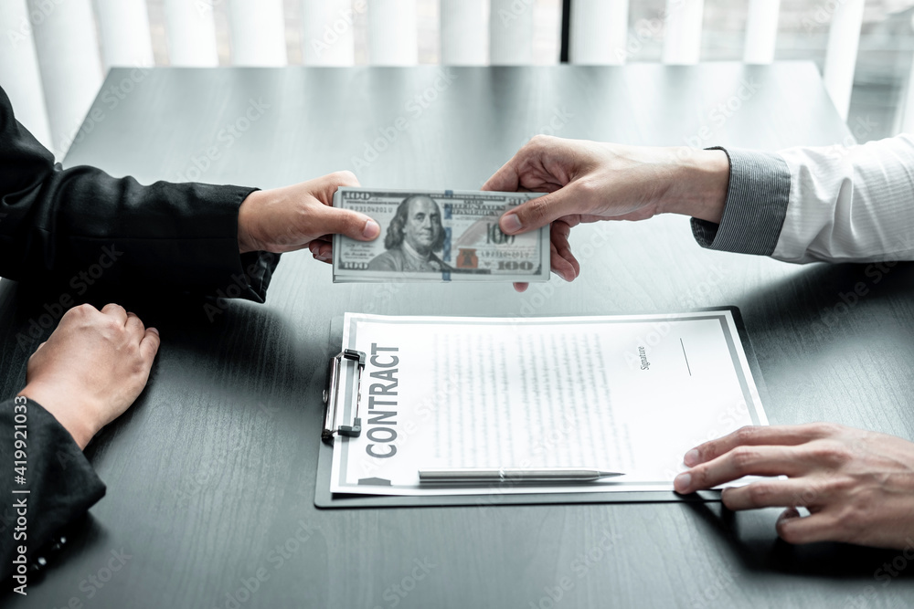 Businessman giving bribe money to businesswoman to bribing deal ...