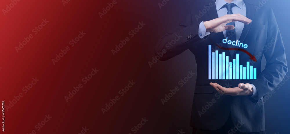 Business man holding holographic graphs and stock.Decline, decrease ...