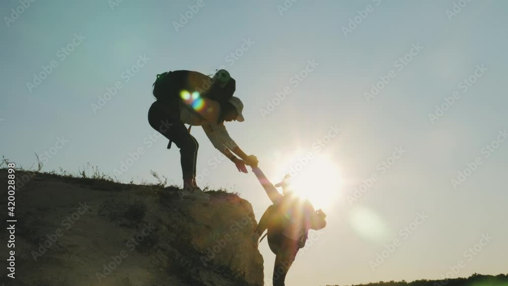 Teamwork helping hand. Family team tourists lends helping hand on climb cliffs mountains. Mom ...