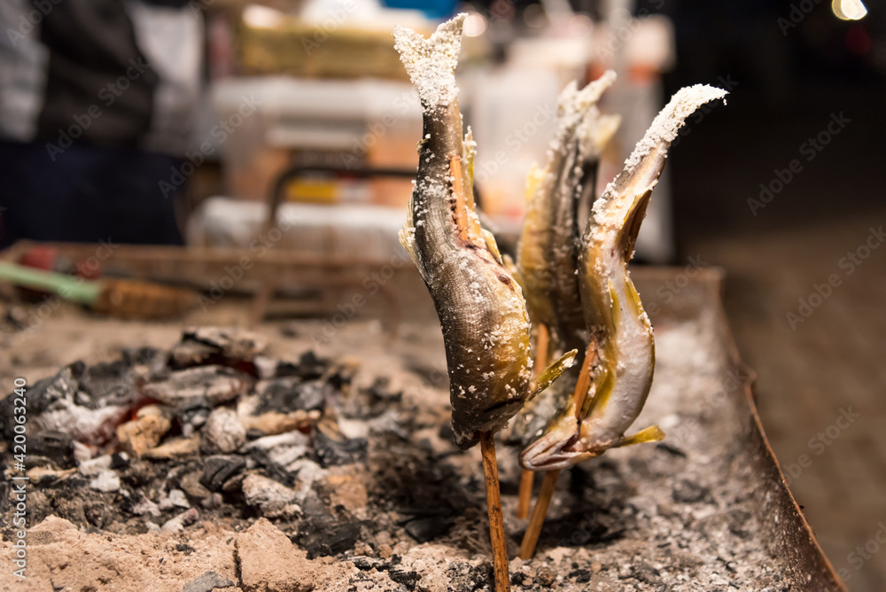 Grilled Ayu fish with salt are wasted by wood stick. Simple ...