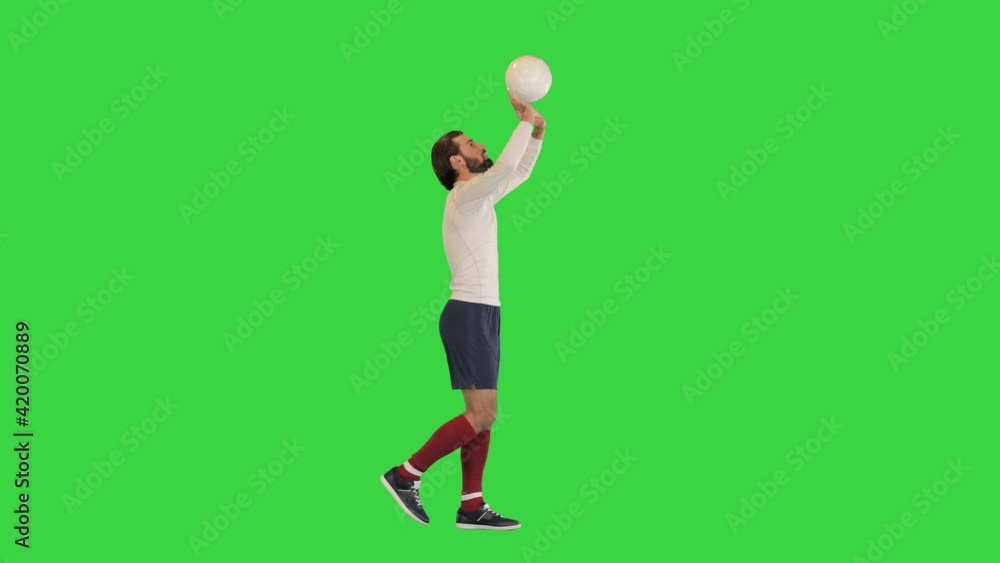 Football sportsman walking and bouncing a ball in hands like a ...