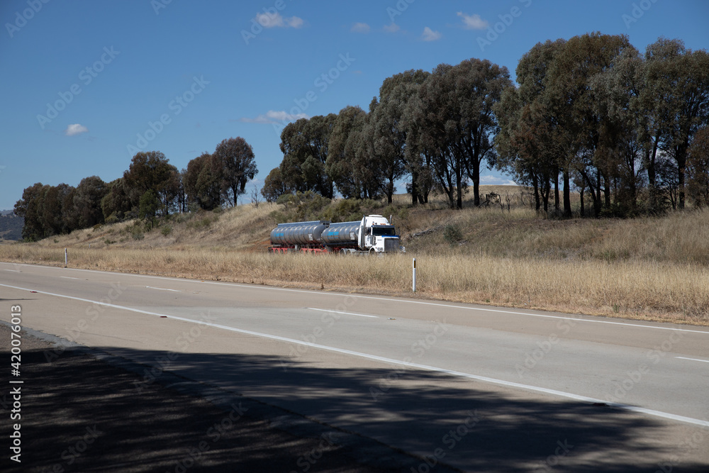 Truck on a freeway with plane flying overhead in Australian Country ...