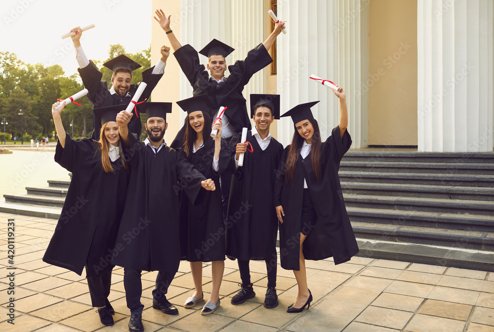 Group of happy smiling cheerful university graduates posing with ...