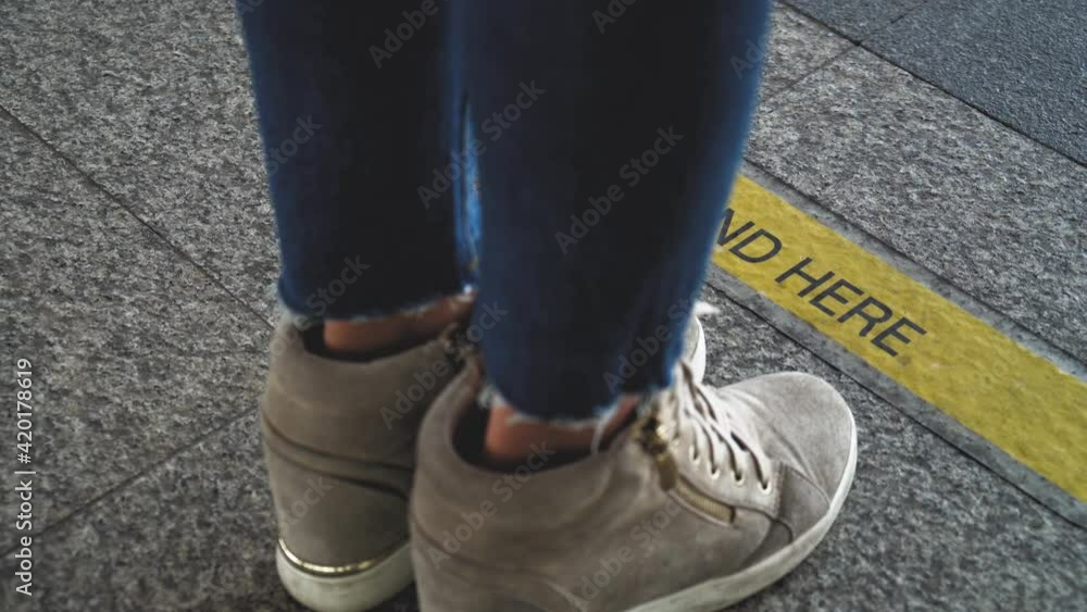 Safety warning 'Stand behind the yellow line' sign near train platform ...