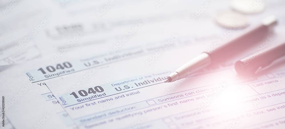 Annual tax reporting. Tax form on the table. Financial statements for ...