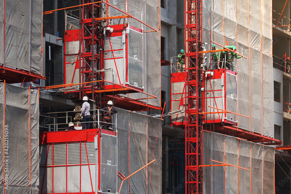 Engineer working inspecting outdoor passenger lift system, Elevator ...