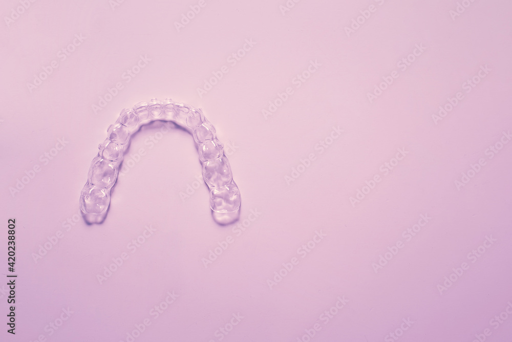 Invisible dental teeth brackets tooth aligners on pink background ...