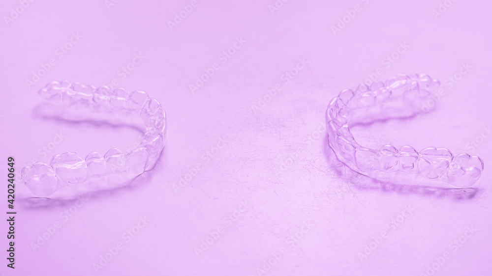 Invisible dental teeth brackets tooth aligners on pink background ...