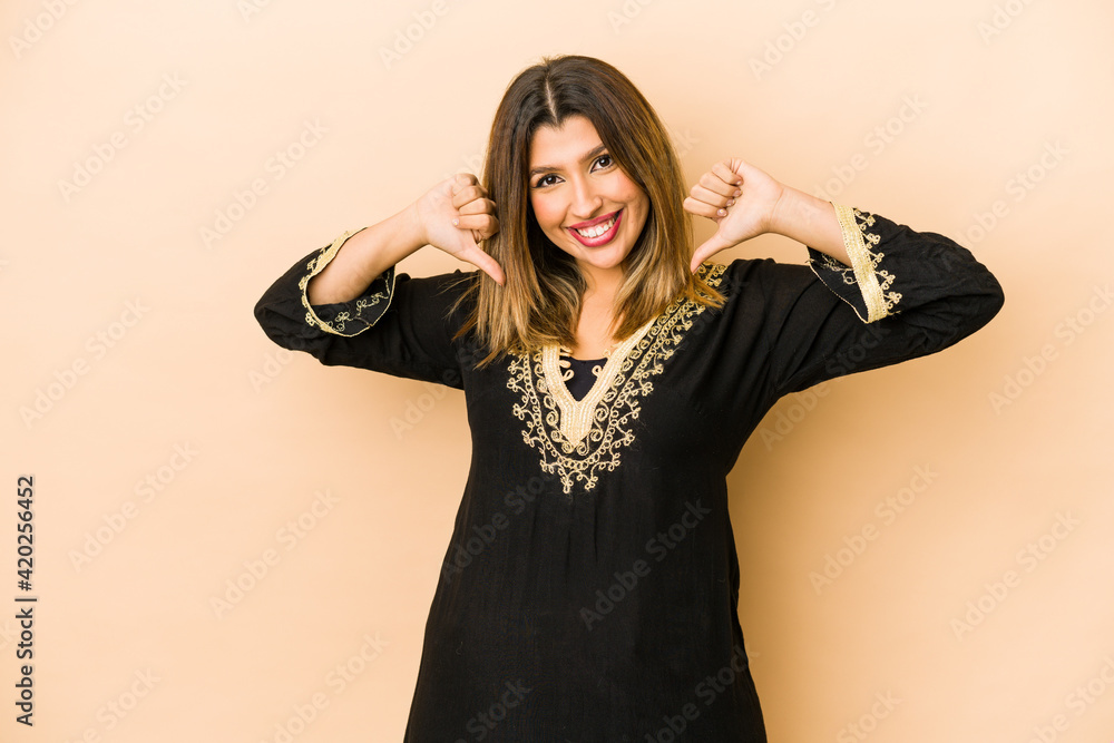 Young indian woman wearing traditional clothes isolated feels proud and ...