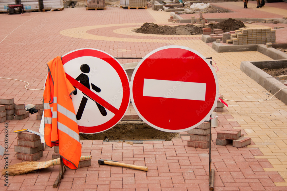 Paving slabs laying works. Prohibitory road signs. Repair of the ...