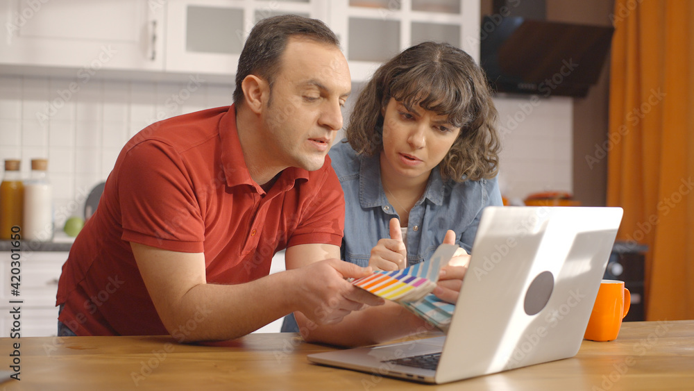 Young couple choosing colors from the color guide palette. The newly ...
