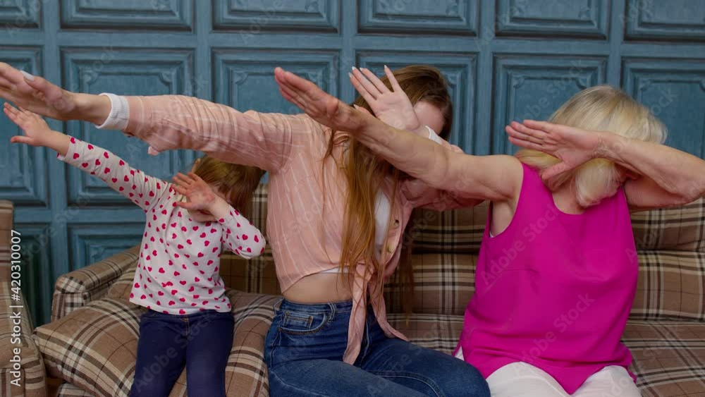 Young woman doing dab gesture internet meme with senior old grandmother ...