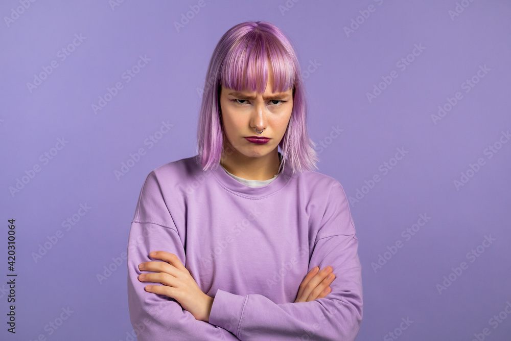 Angry offended woman with dyed purple hair keeping arms crossed and ...