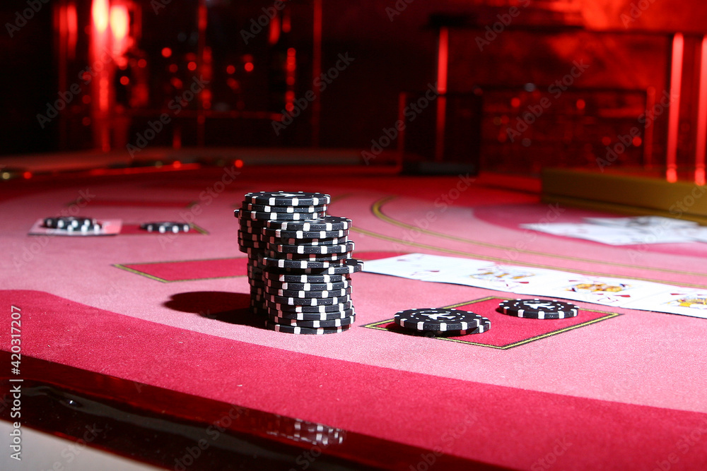 Red card table. A tower of chips. Stock Photo | Adobe Stock