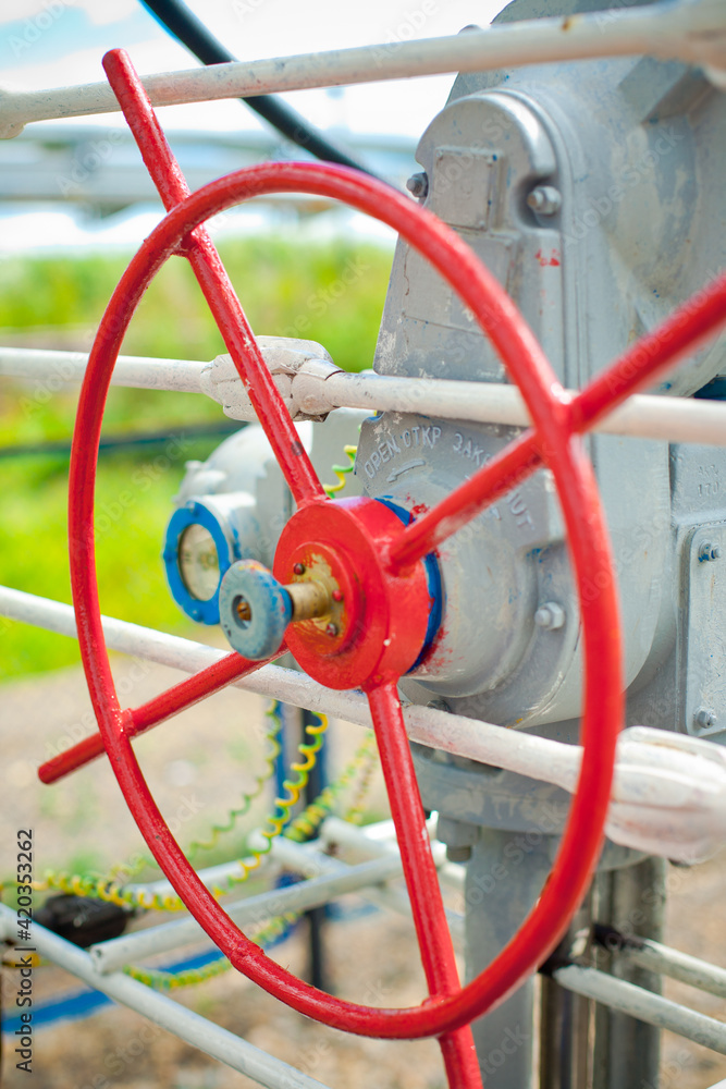 Oil and gas field. Gate valves that control the flow of gas from wells ...