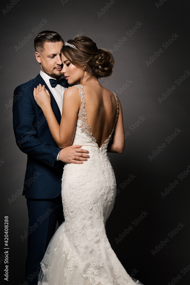 Wedding Couple Fashion Portrait. Bride Back view and Groom embracing ...