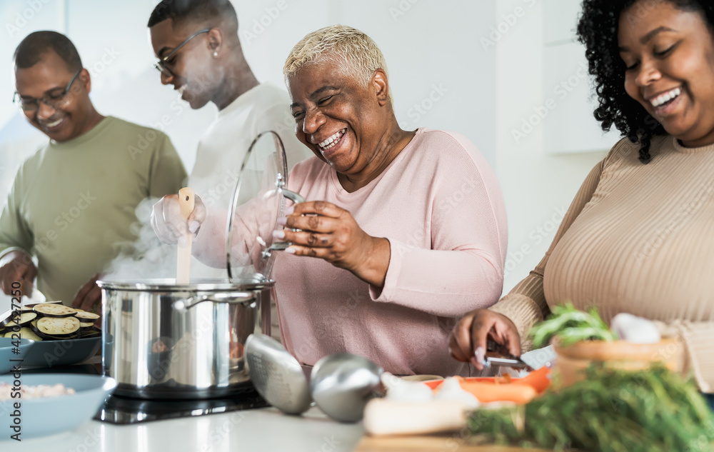 Happy black family having fun cooking together in modern kitchen - Food ...