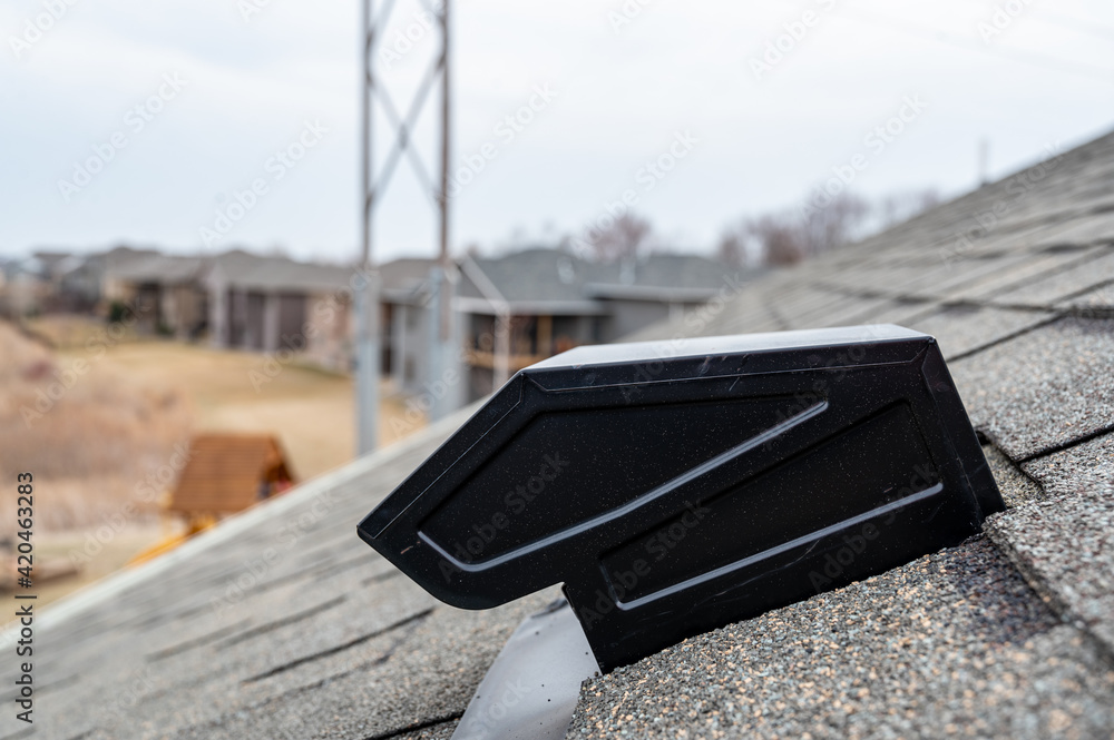 Static vent installed on a shingle roof for passive attic ventilation ...