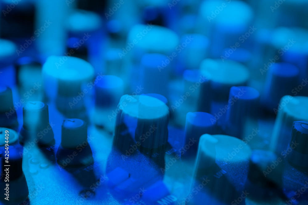 Dj sound mixer in bright blue neon lights.Disc jockey midi controller ...